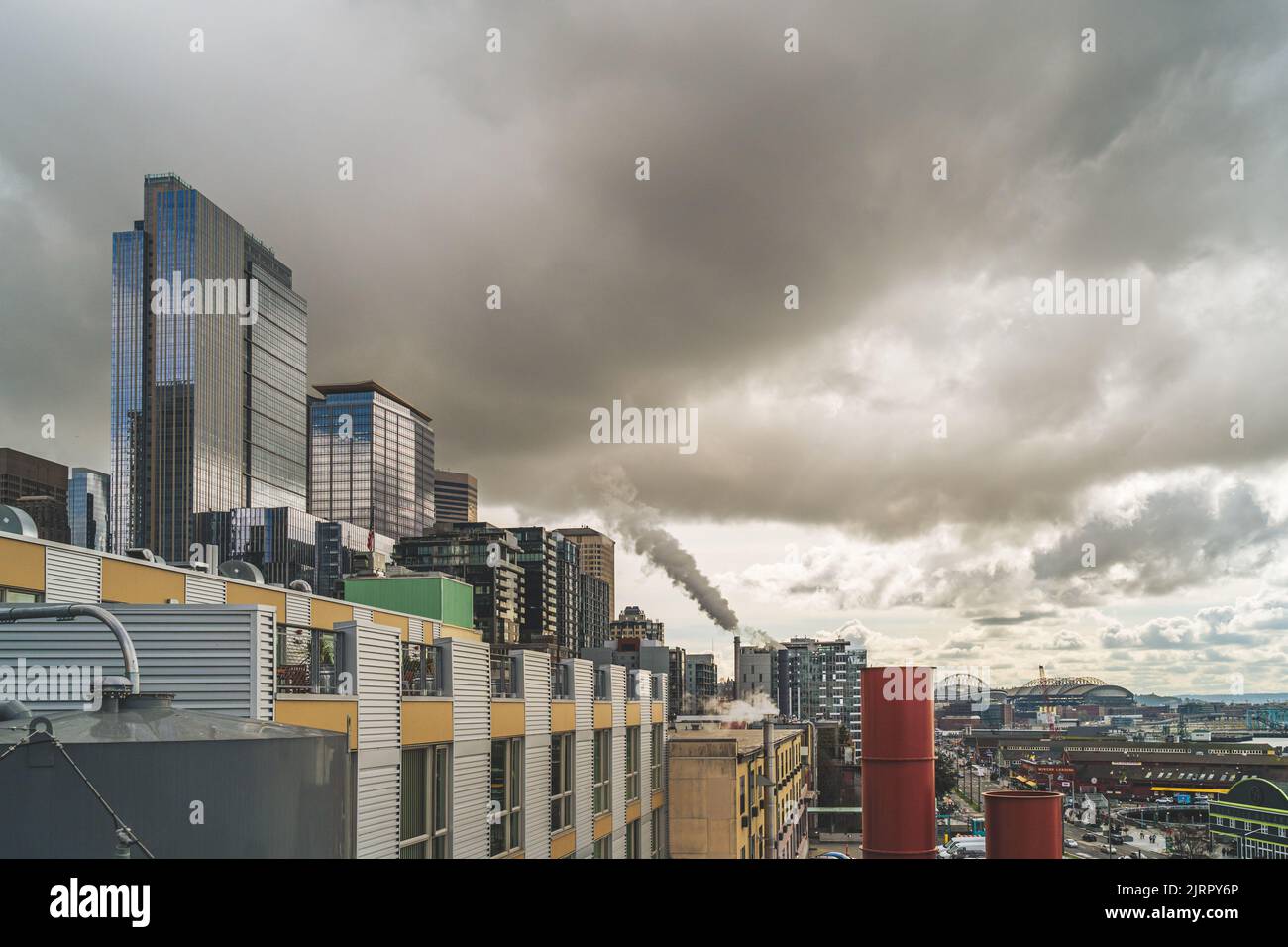 A cityscape of Seattle on a cloudy day with dark steam rising from a ...