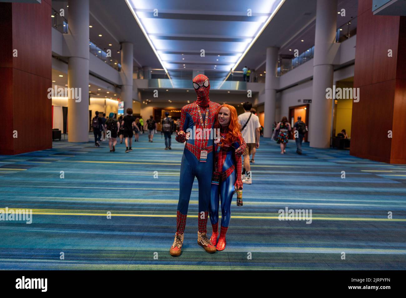 People dressed as comic book characters pose for a picture at Fan Expo ...