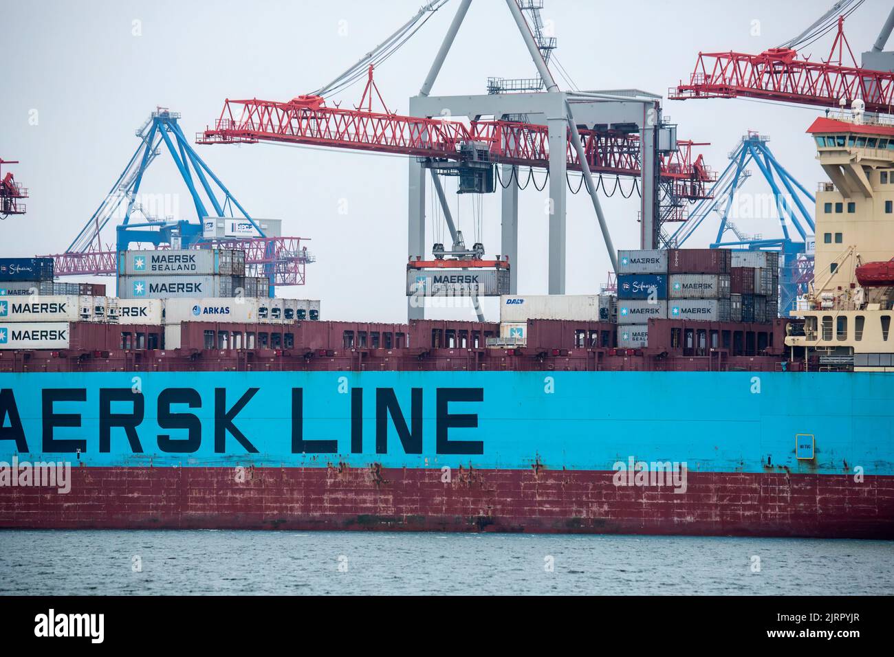 Container ship MAERSK in port at container terminal. Ships of container ...