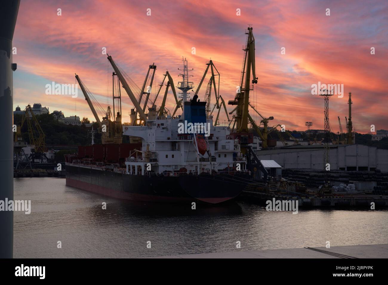 Vessel dry cargo on loading, unloading in port. Bulker in port Stock Photo - Alamy