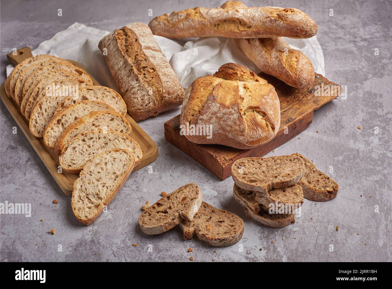 A different types of bread with cut pieces on marble surface Stock ...
