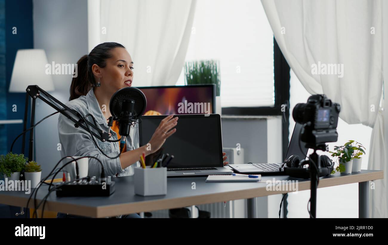 Famous influencer doing high tech laptop product review while recording ...