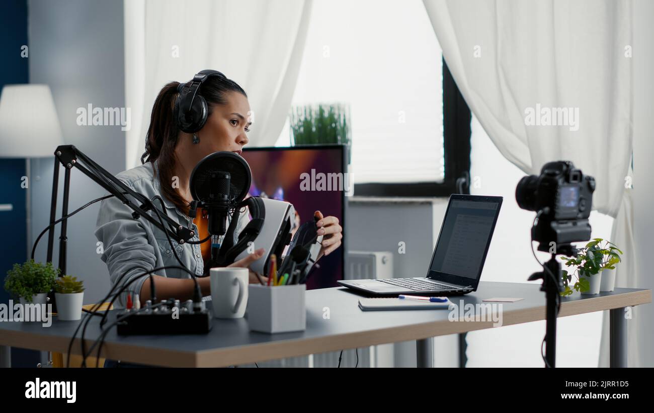 Famous influencer reviewing high tech VR headset while filming ...