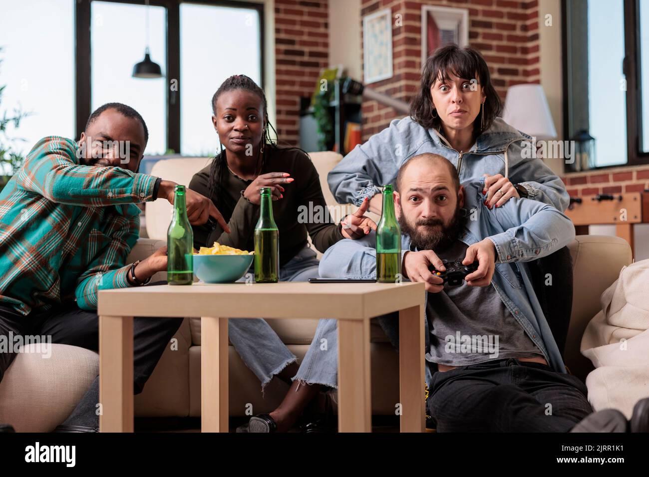 Group of young people having fun with video games competition and ...