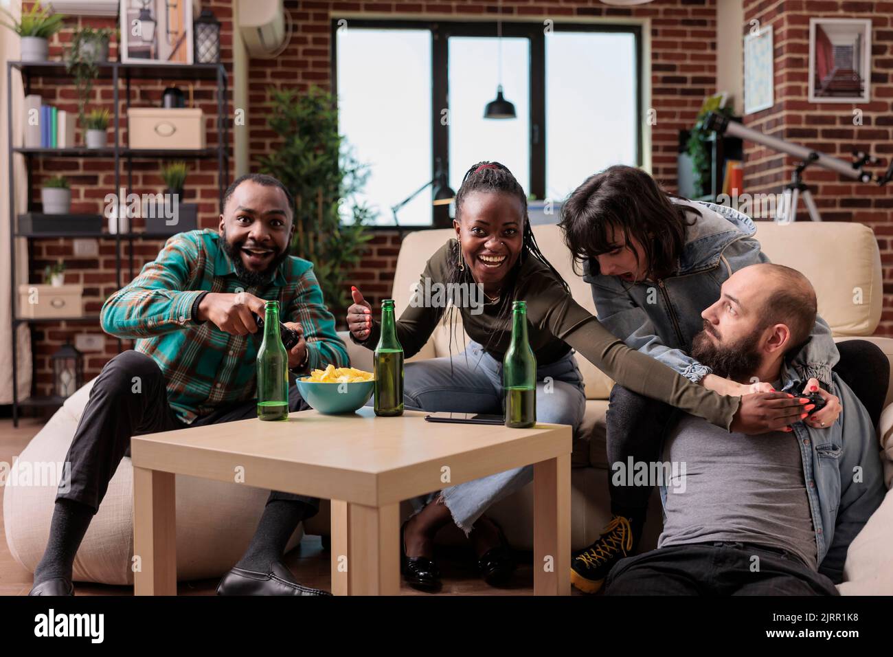 Cheerful group of people having fun with video games strategy, playing ...