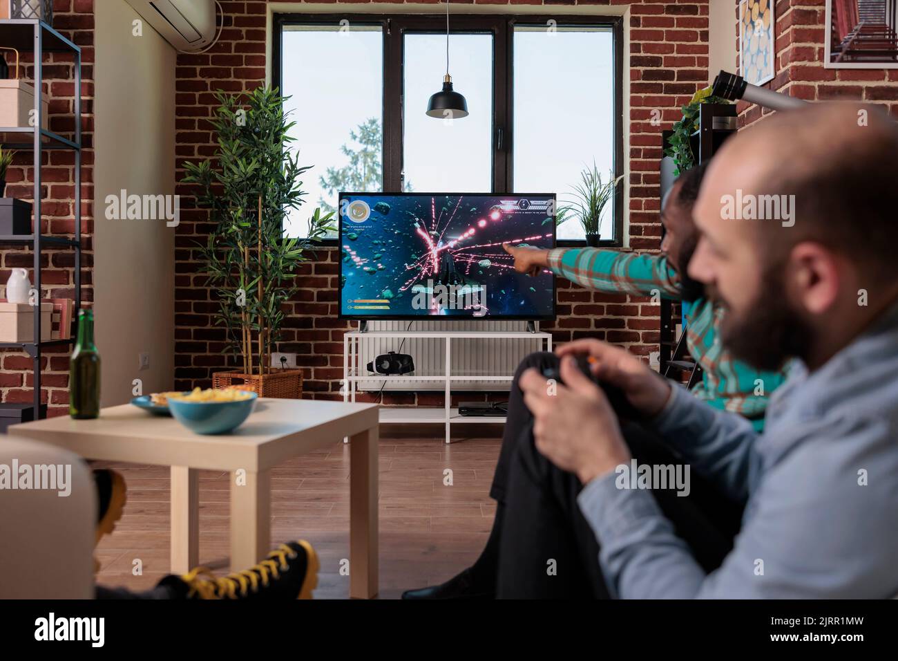 Diverse group of men playing online video games on tv console, gaming ...