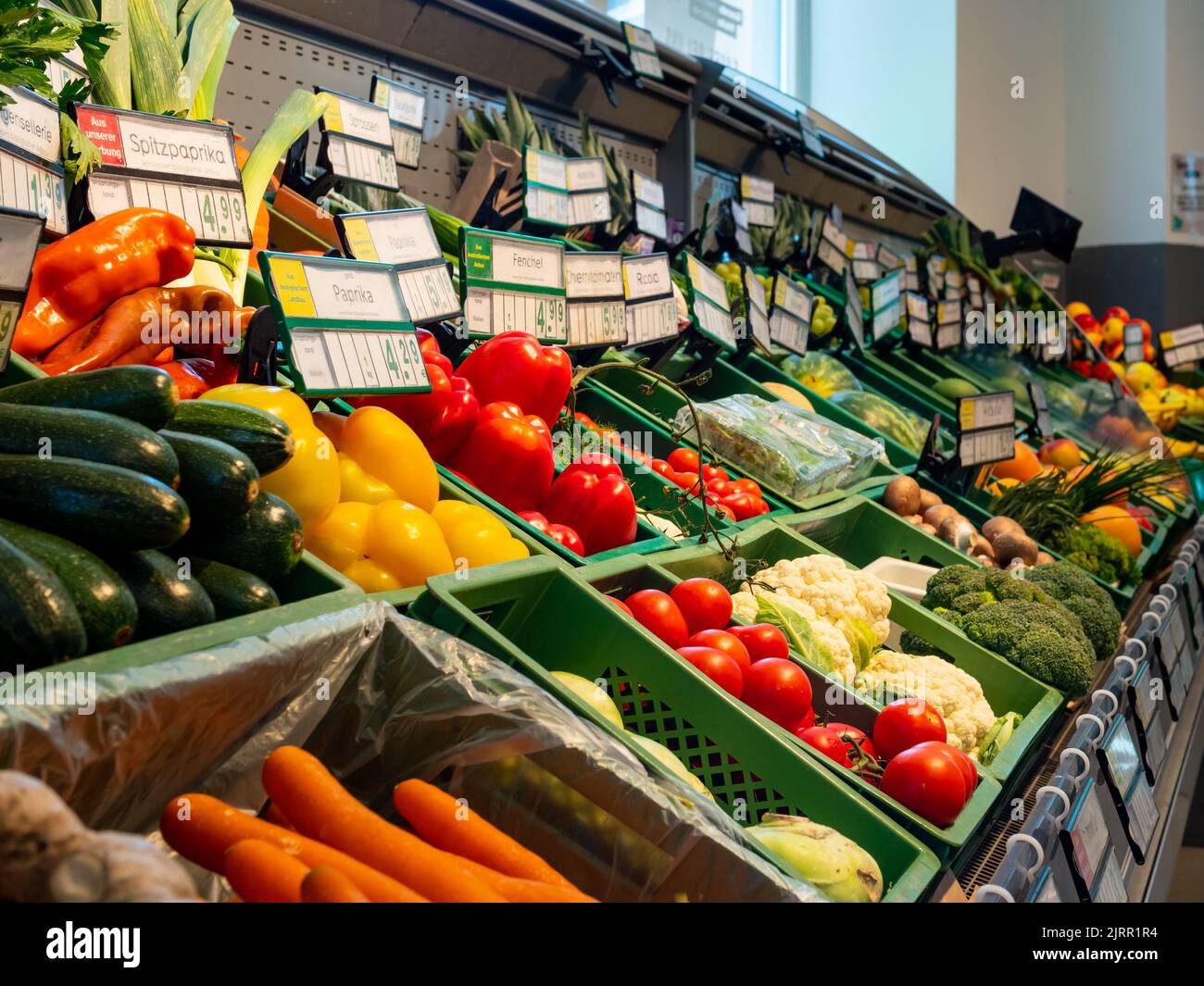 Fresh vegetables and fruits in shelves in a supermarket. Colorful ...
