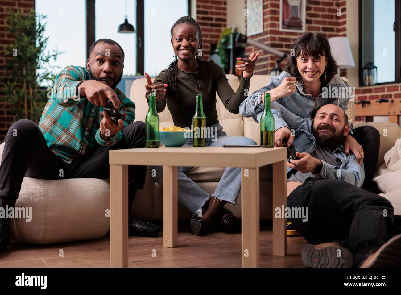 Diverse group of people enjoying video games play on gaming console ...
