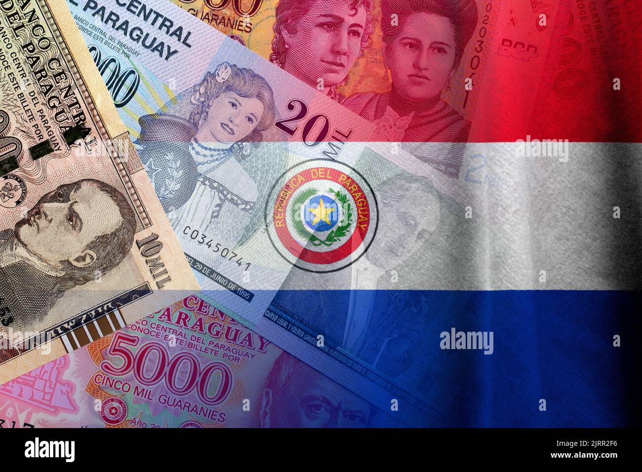 Guarani cash bills and flag of Paraguay (money, finance, business ...