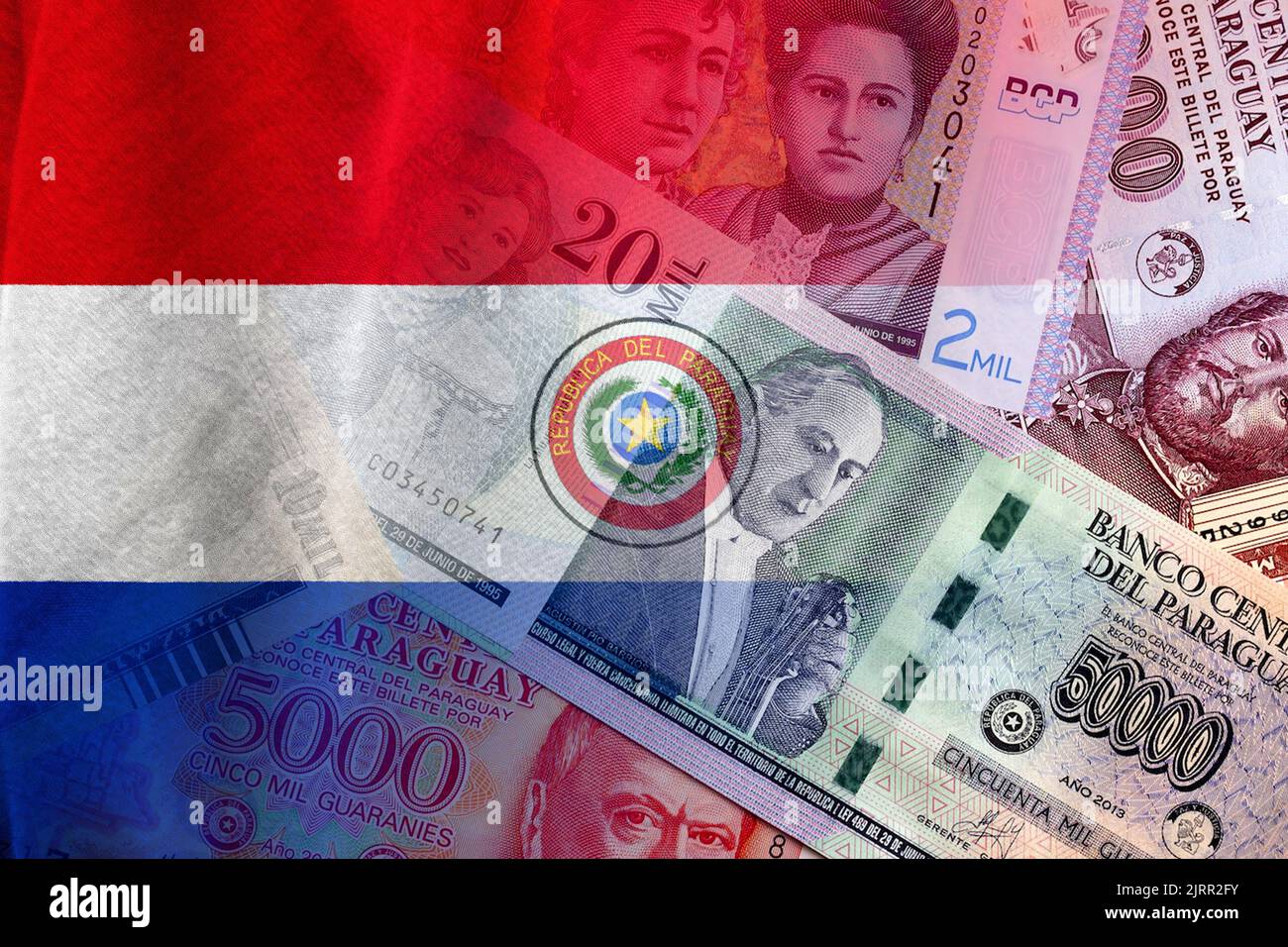Guarani cash bills and flag of Paraguay (money, finance, business ...