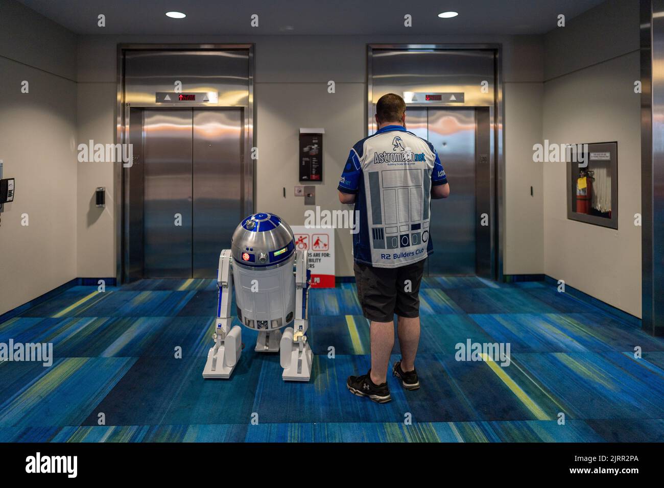 A man and his remote control R2D2 from the Star Wars franchise wait for the elevator at Fan Expo ...