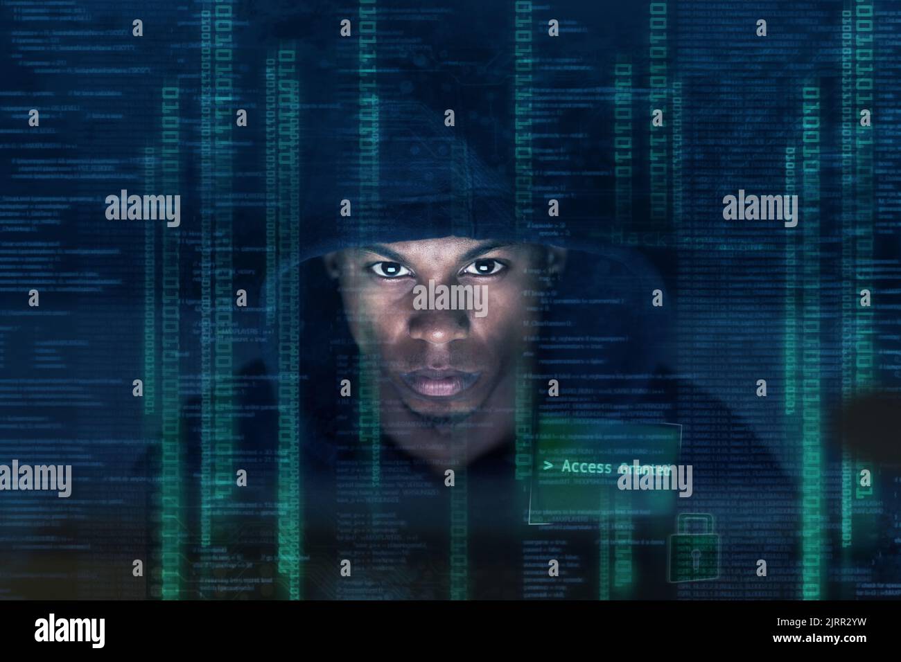 Engrossed in the matrix. Cropped portrait of a young man hacking into a ...