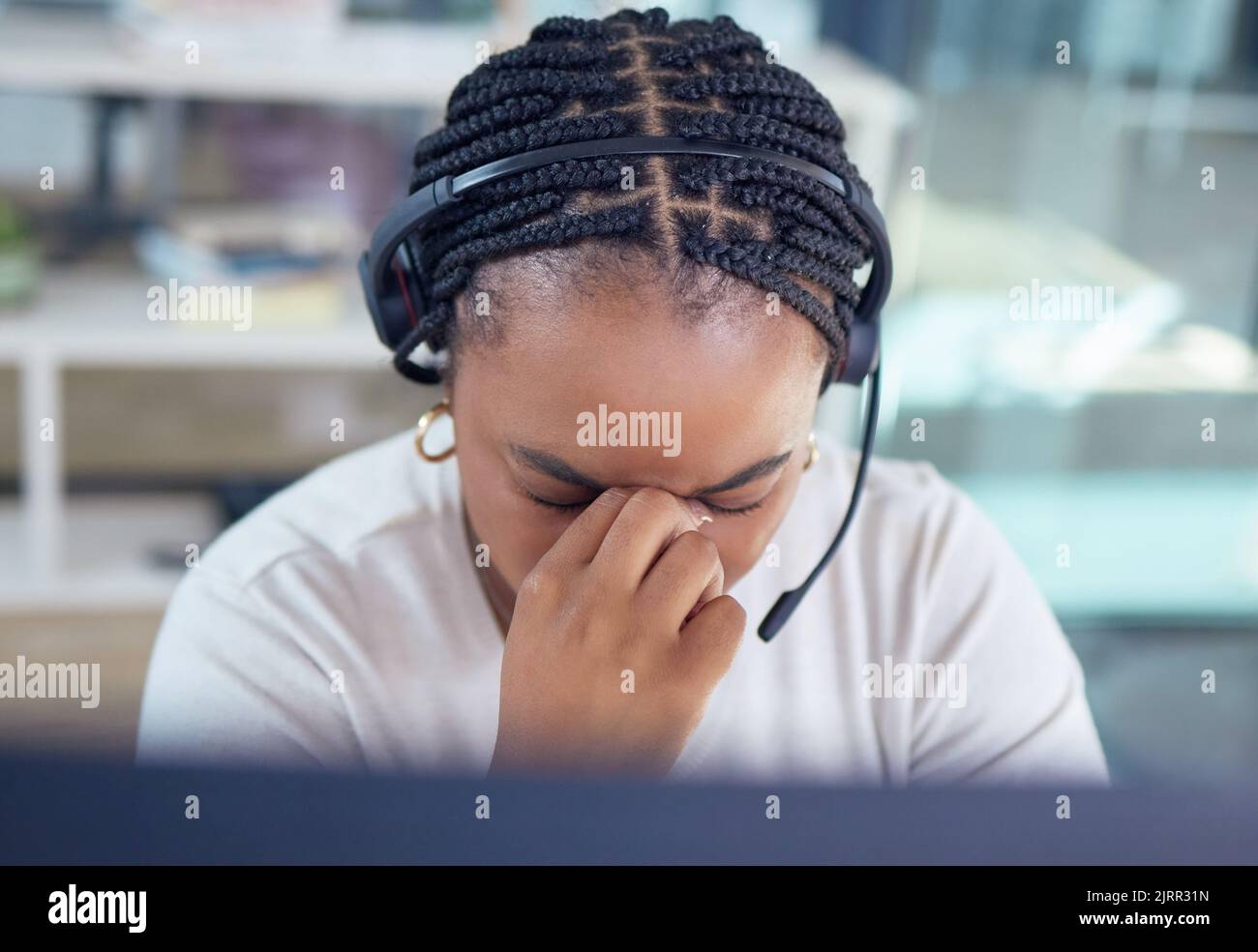 Stress, burnout and sad call center agent with a headache and office ...
