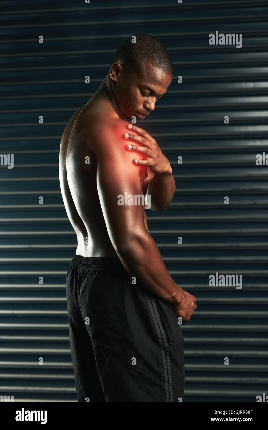 That workout took a toll on his shoulder. Studio shot of an athletic ...