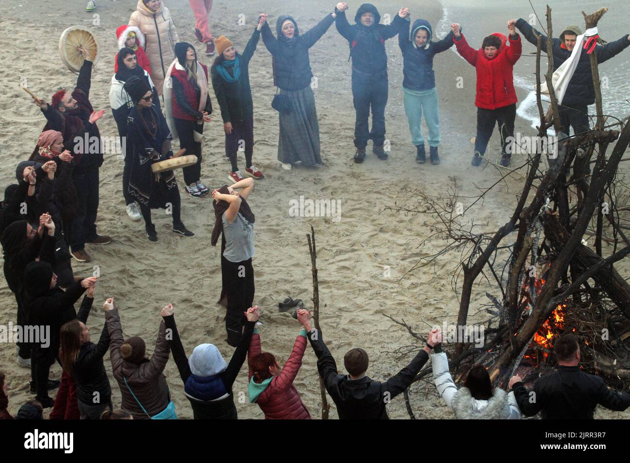 People are seen dancing near the fire while holding hands. Maslenitsa ...