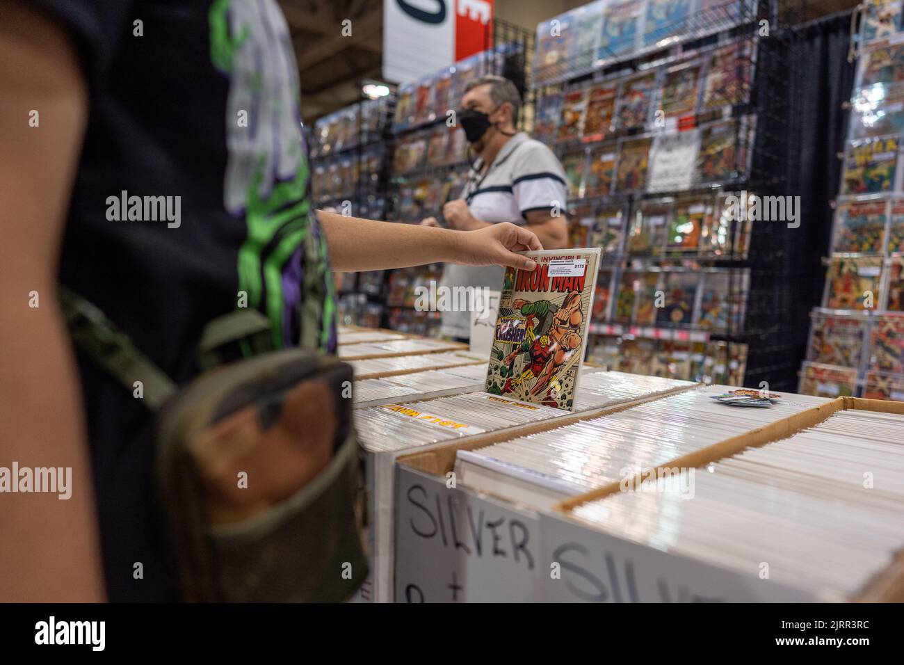 People look through boxes of comic books on the first day of Fan Expo ...