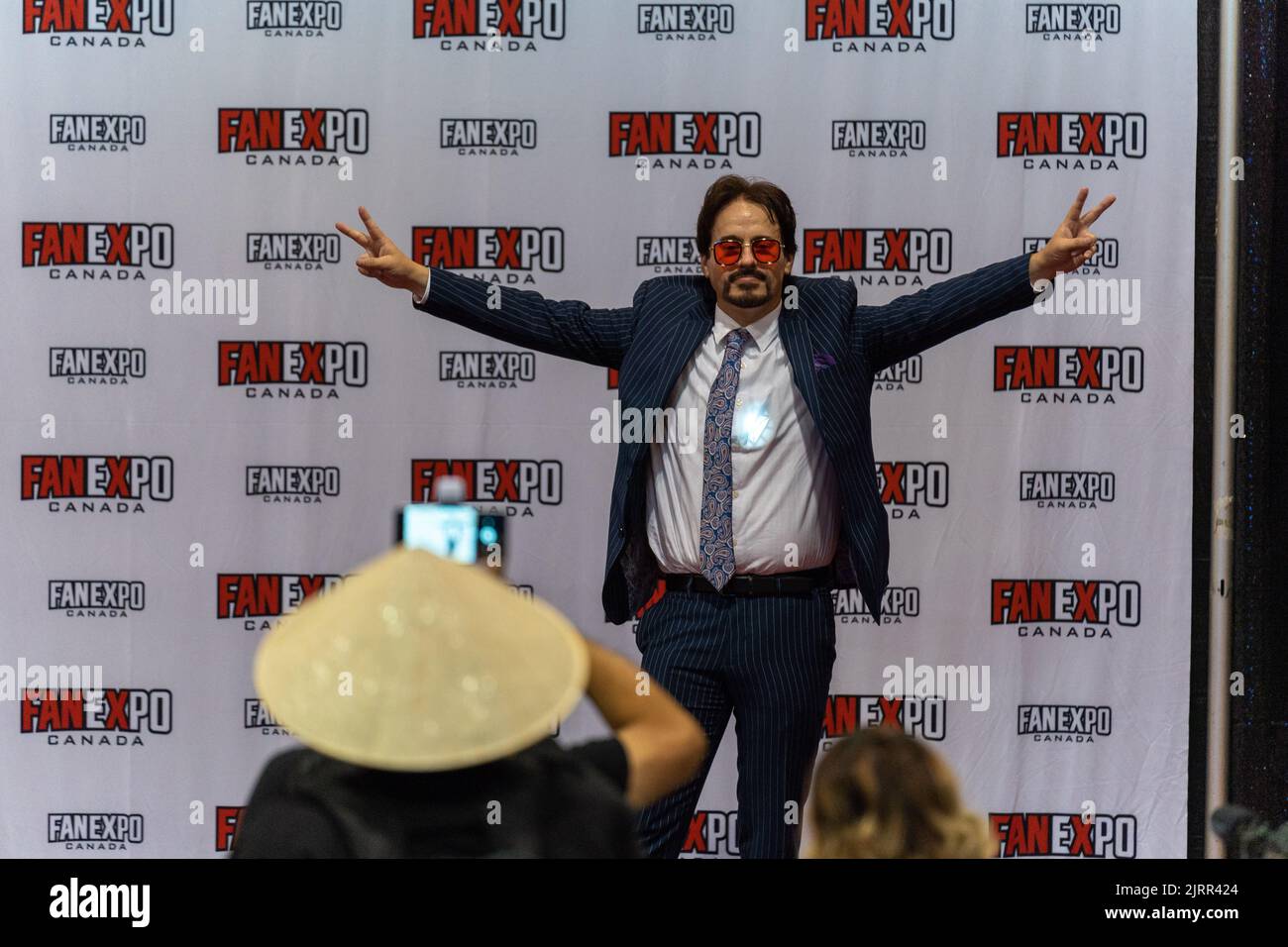 A man dressed as Marvel’s Tony Stark poses for a photo during the ...