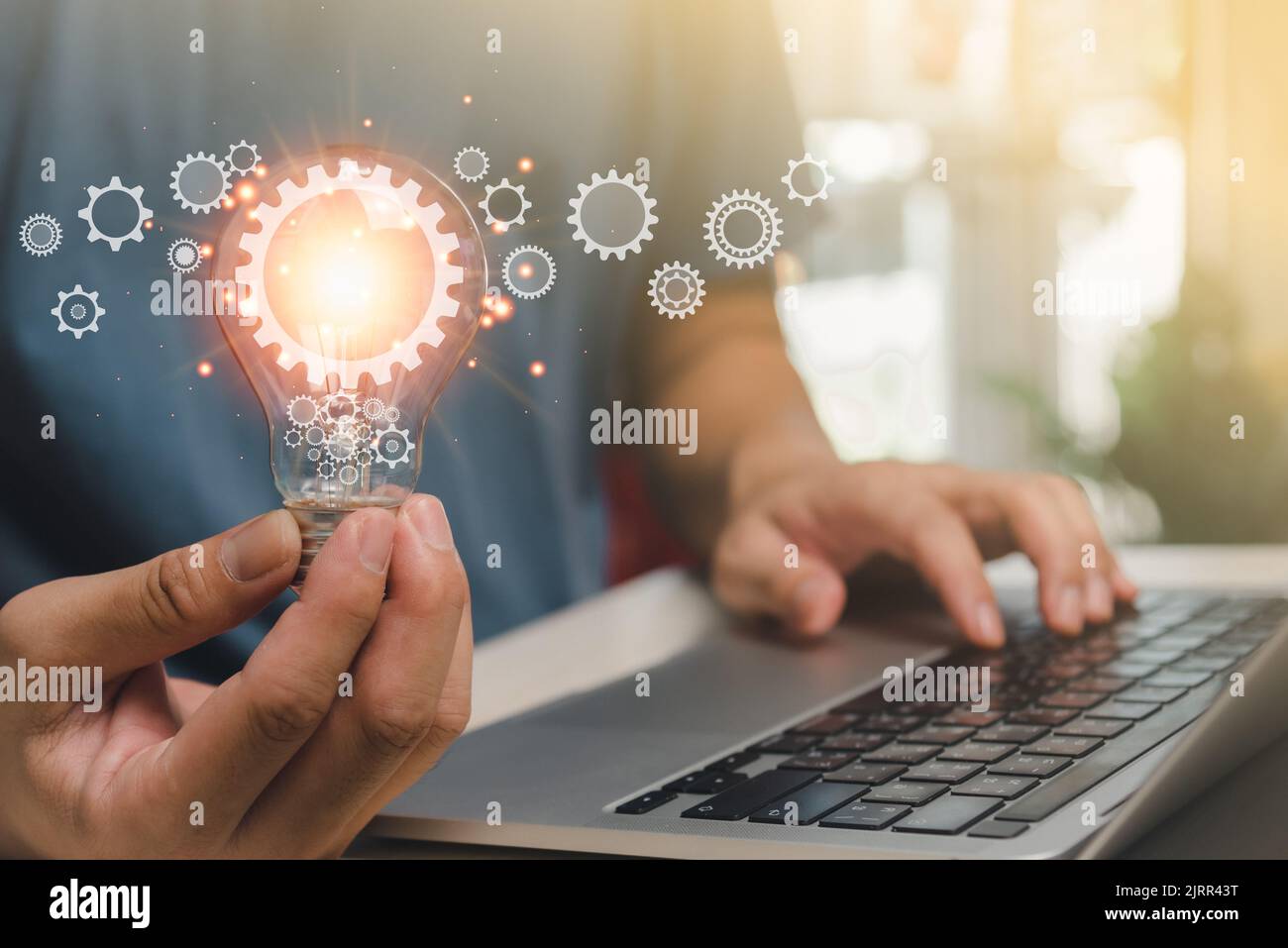 Hand light bulb gear hi-res stock photography and images - Alamy