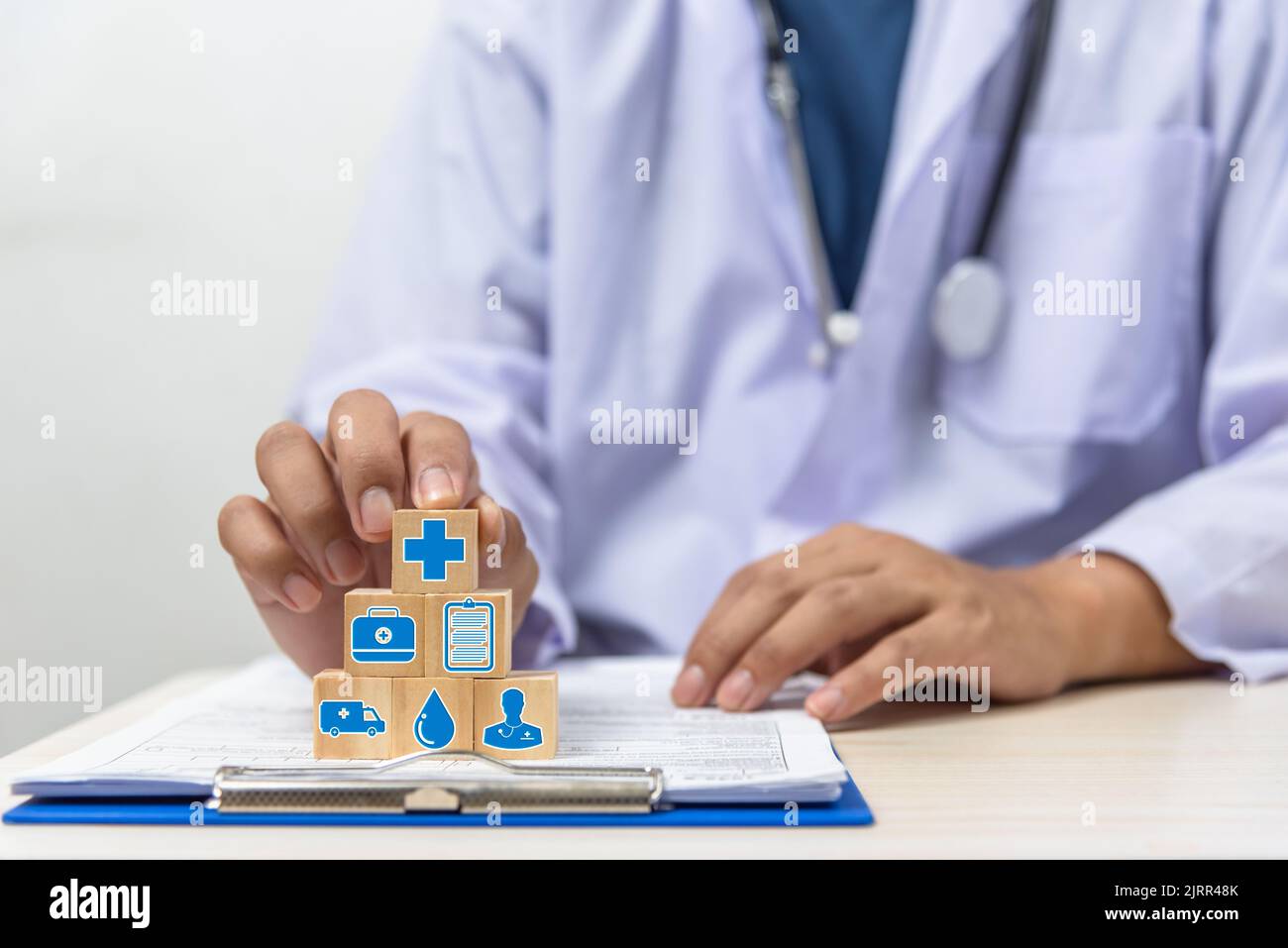 Hand holding wooden cubes block with insurance health car medical ...