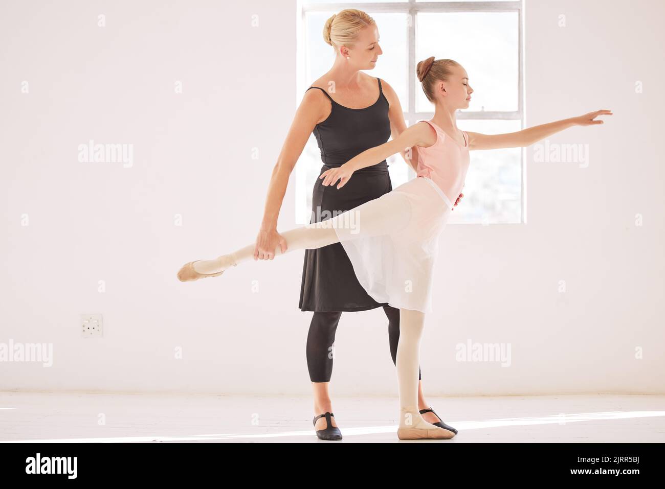 Ballet teacher teaching a student in a dance class or studio at an art ...
