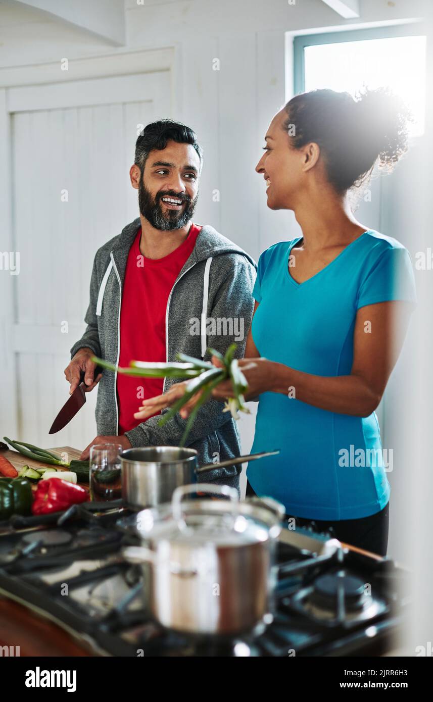 Youre my favourite sous chef. a happy couple cooking together in their ...