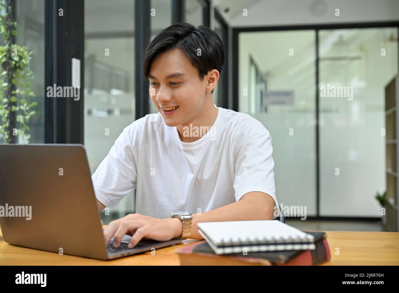 Smart and handsome young Asian male office worker or tech engineer ...