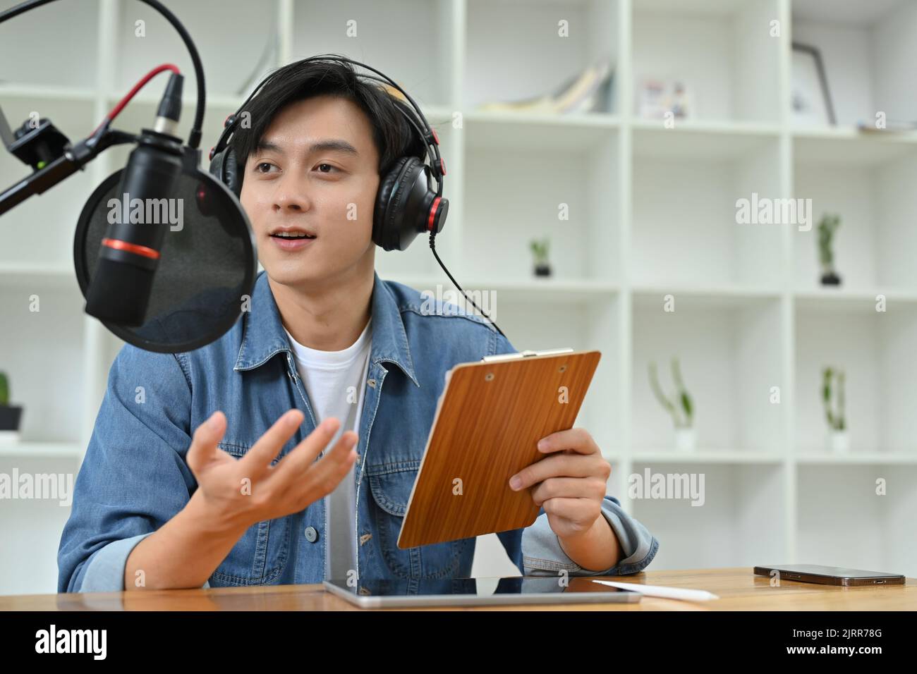 Talented young Asian male radio host enjoys talking with his online ...