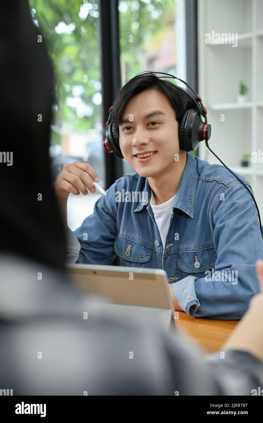 Portrait, Smart and handsome millennial Asian male radio host or VJ ...