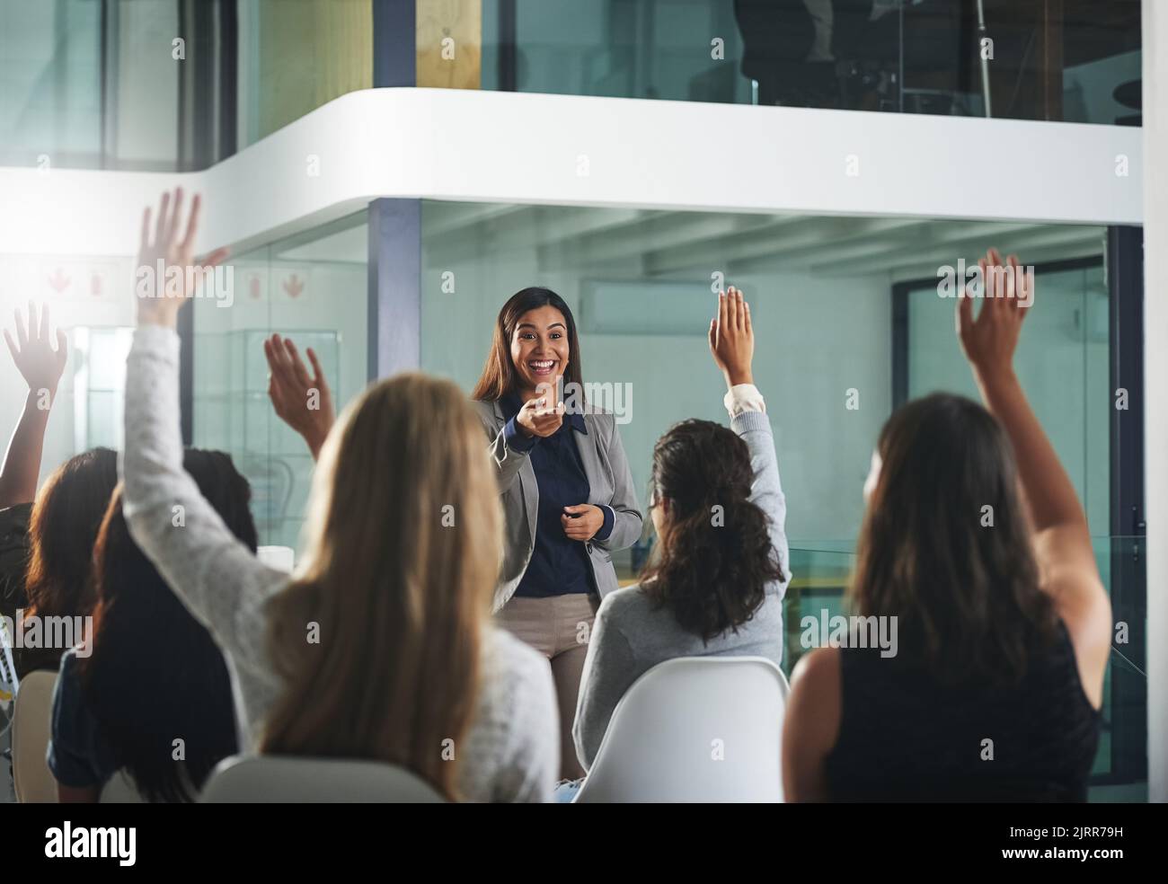 Taking some questions from the audience. a group of businesspeople ...