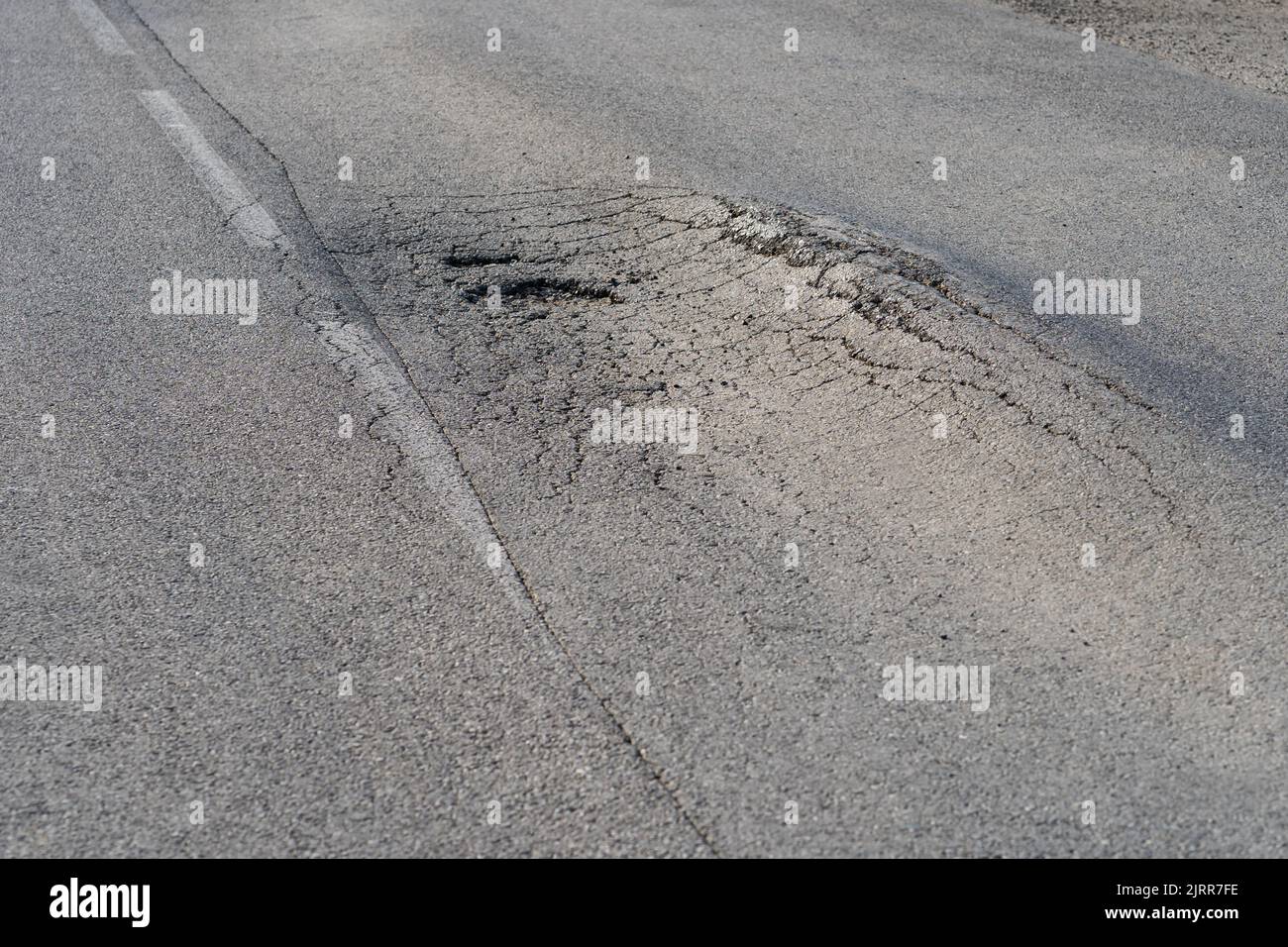Deformed asphalt surface with potholes caused by heavy overloaded ...