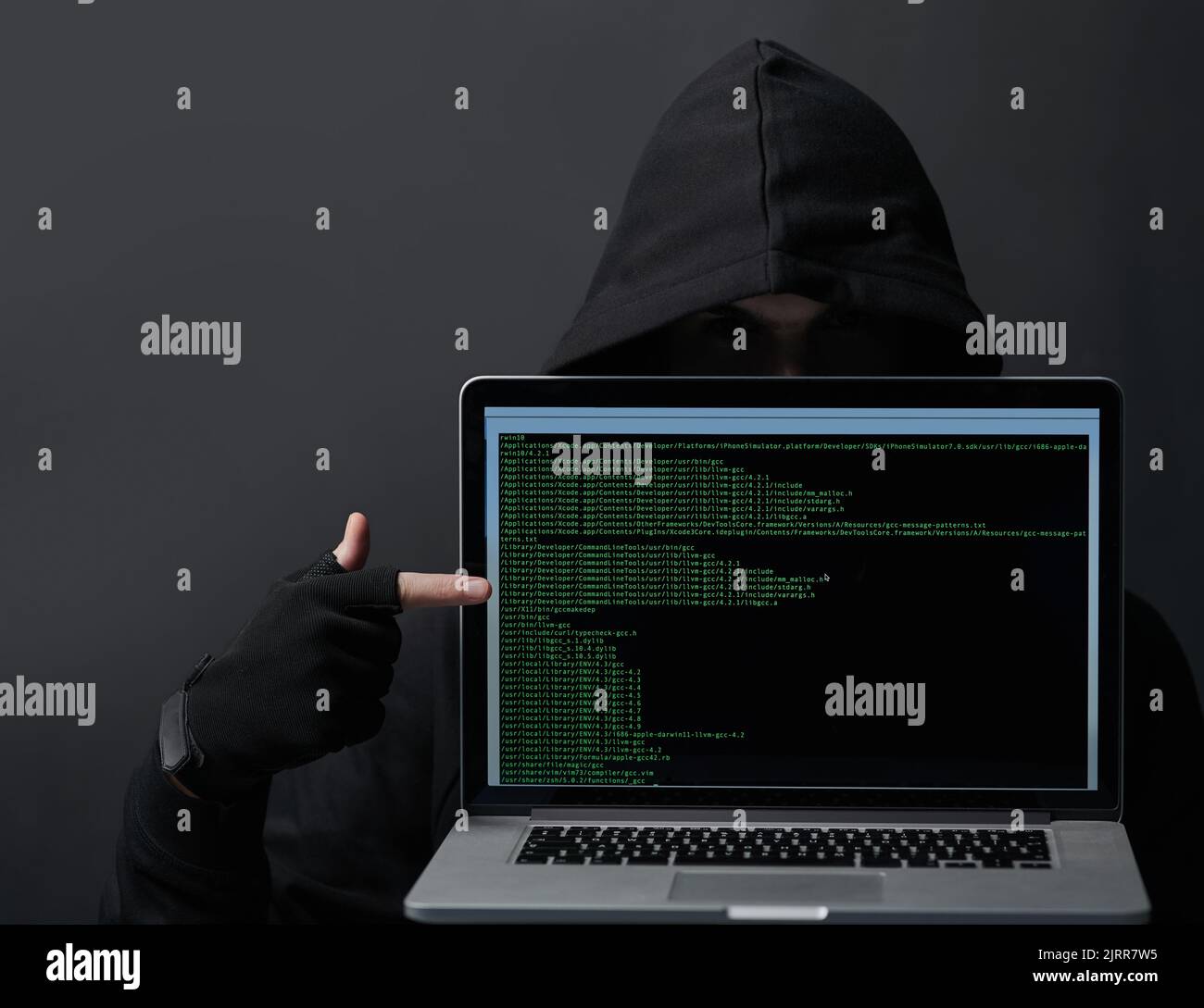 See your data It belongs to me now. an unidentifiable computer hacker holding up a laptop ...