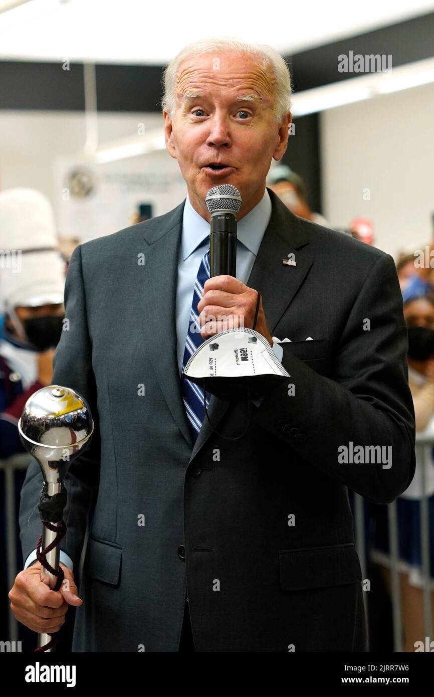 US President Joe Biden holds a marching band leader baton as he ...