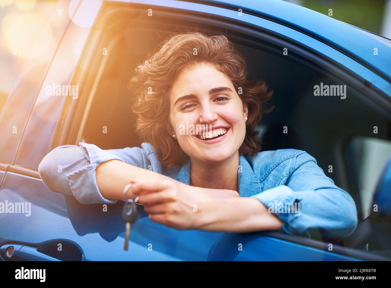 Time to take my new baby for a spin. a happy young woman holding the ...