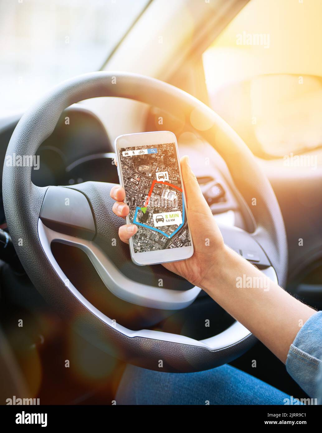 Take the smartest route possible. a woman using her phones gps system ...