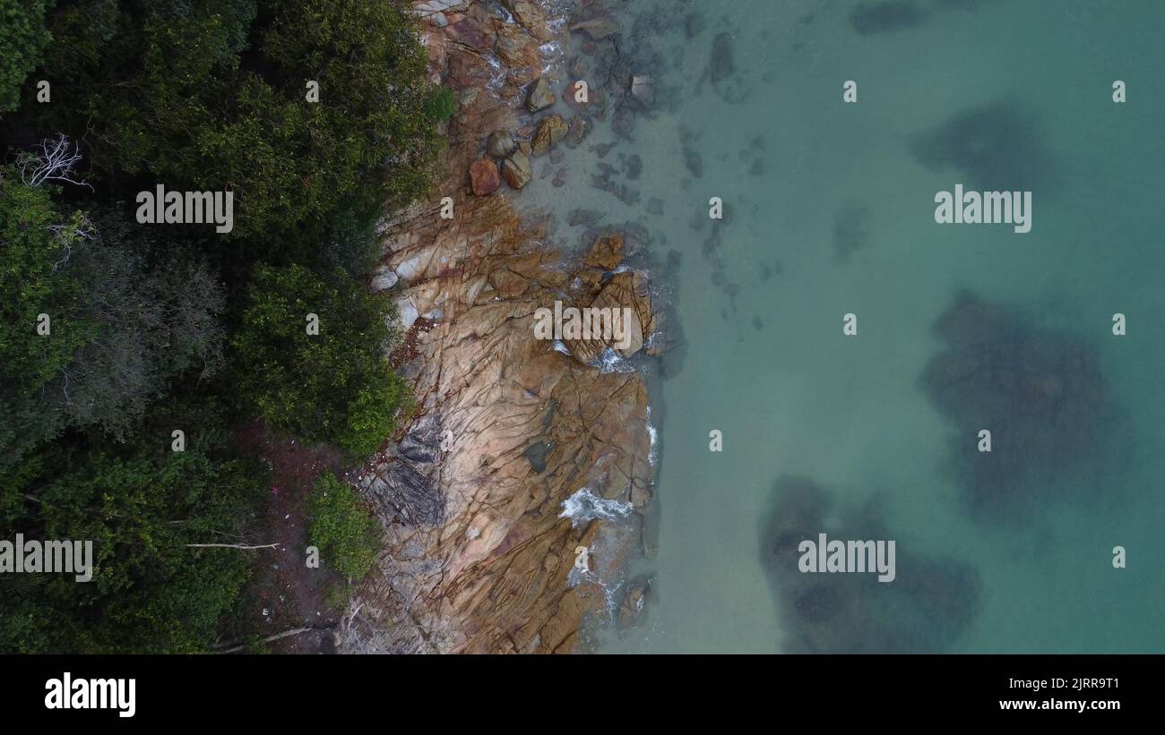 aerial scene of boulders along the sandy beach Stock Photo - Alamy