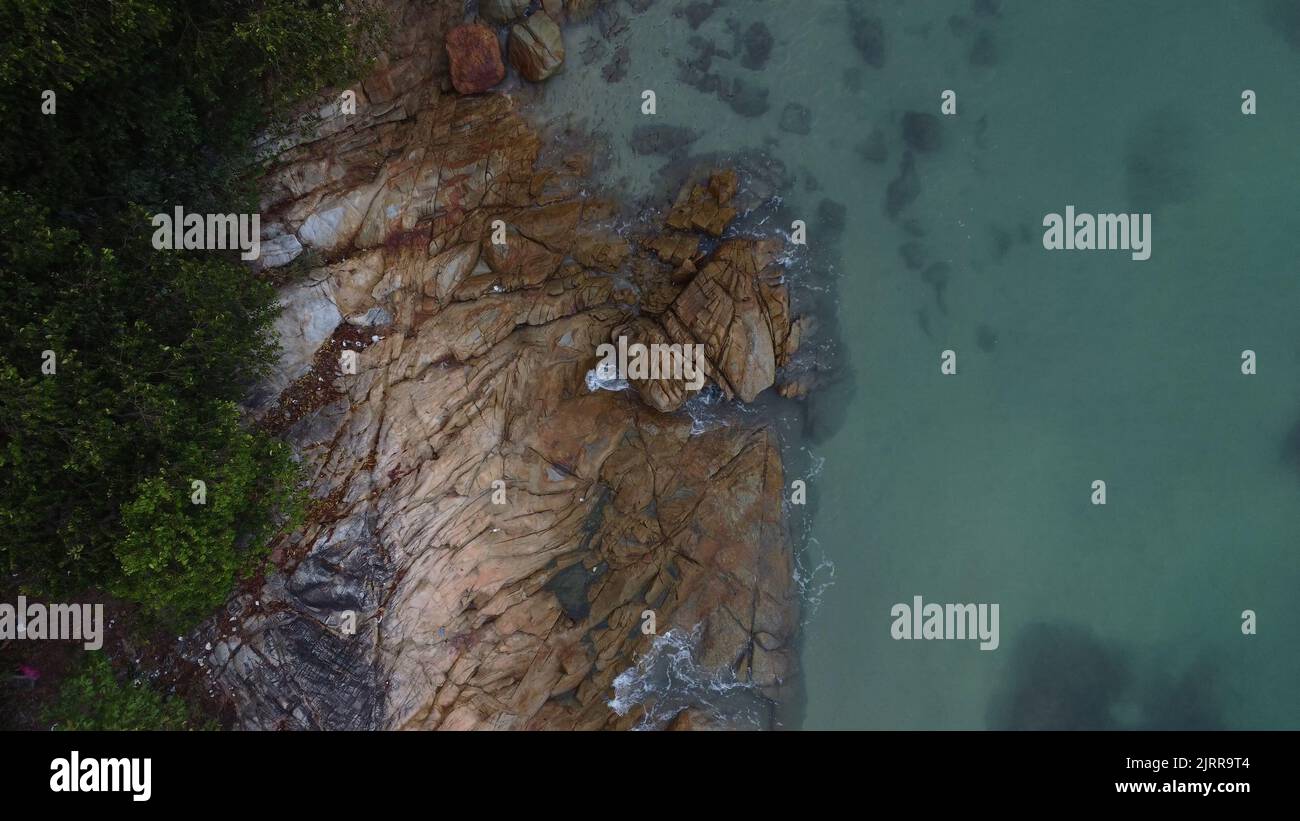 aerial scene of boulders along the sandy beach Stock Photo - Alamy
