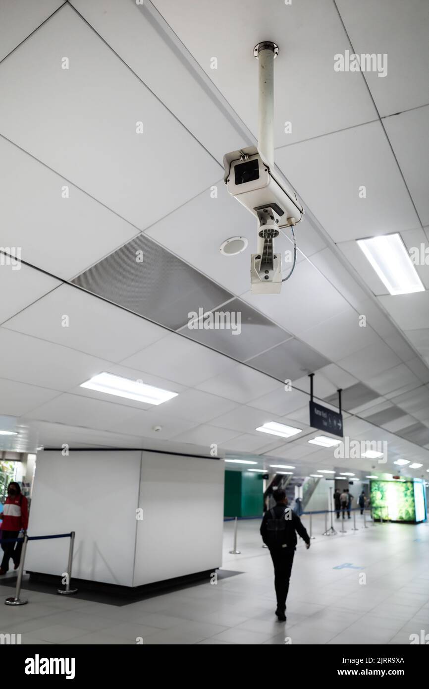 CCTV camera placed high on the ceiling of a city subway station Stock ...