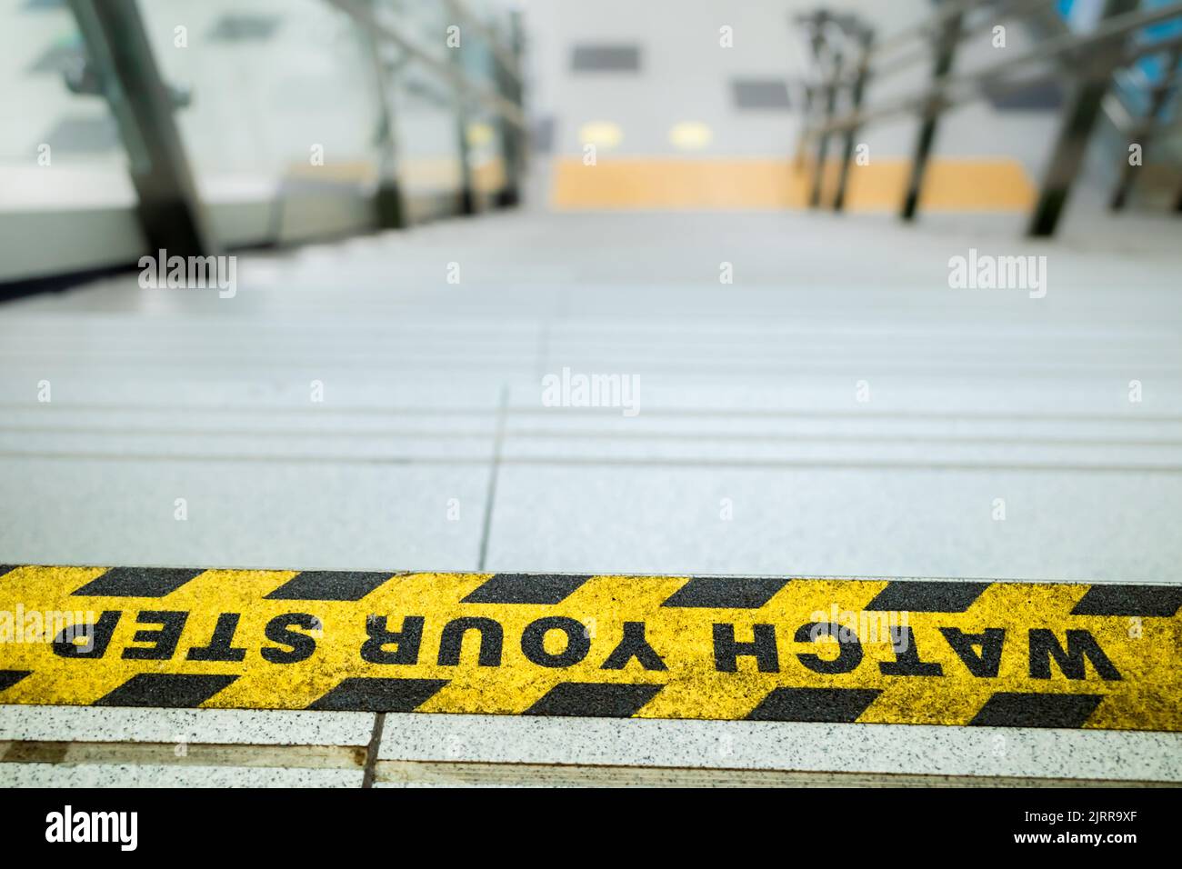 Watch your step sign sticker on the stairs at public area Stock Photo ...