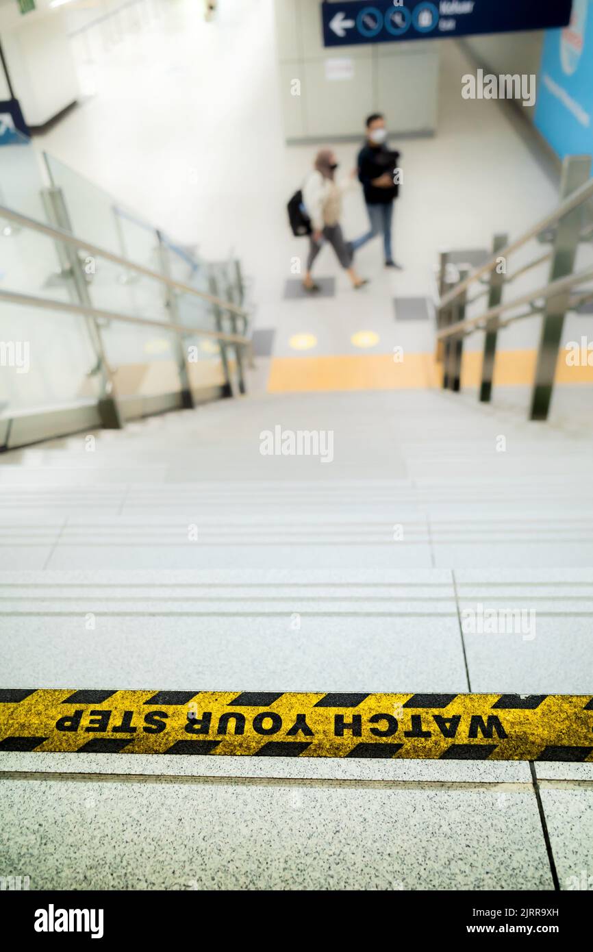 Watch your step sign sticker on the stairs at public area with people ...
