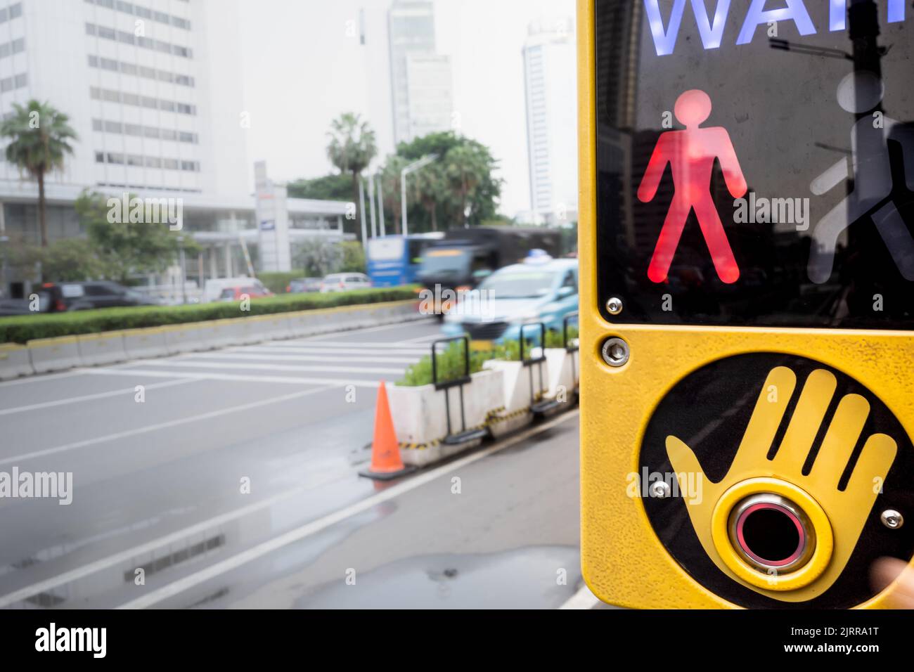 Wait signal sign located at pedestrian crosswalk area on a busy city ...