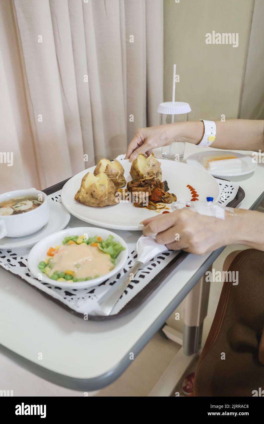 Female patient ready to eat meal with varied menu on hospital bed Stock ...