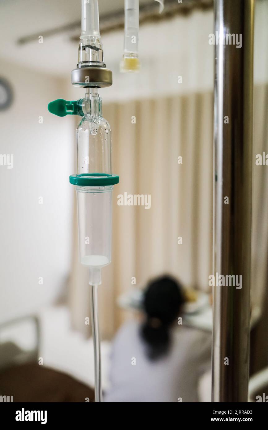 Closeup View of Infusion with Female Patient Sitting on Hospital Bed on ...