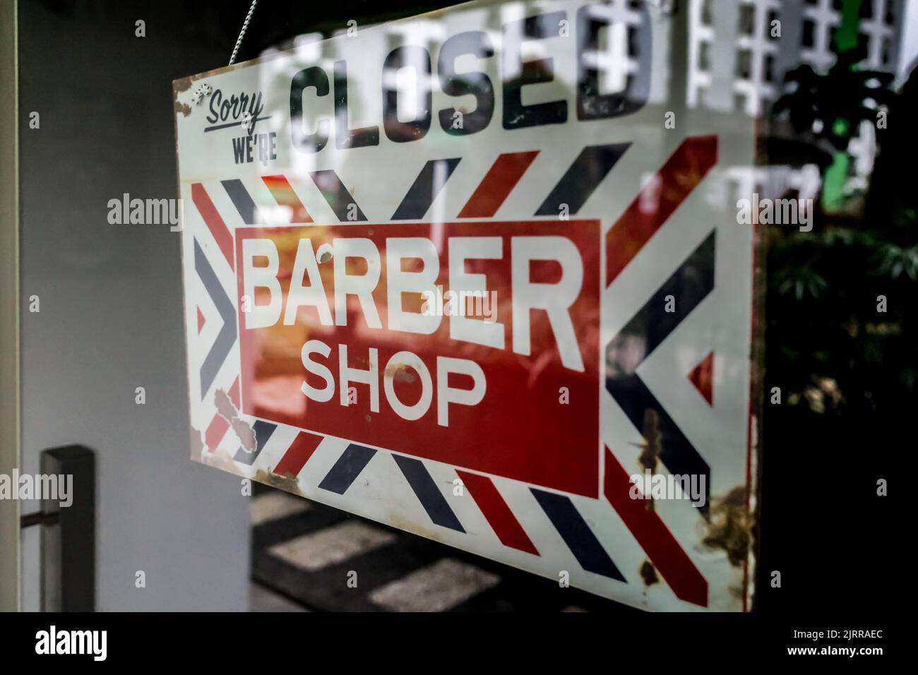 Vintage barber shop closed sign on a glass door. Vintage red white navy ...