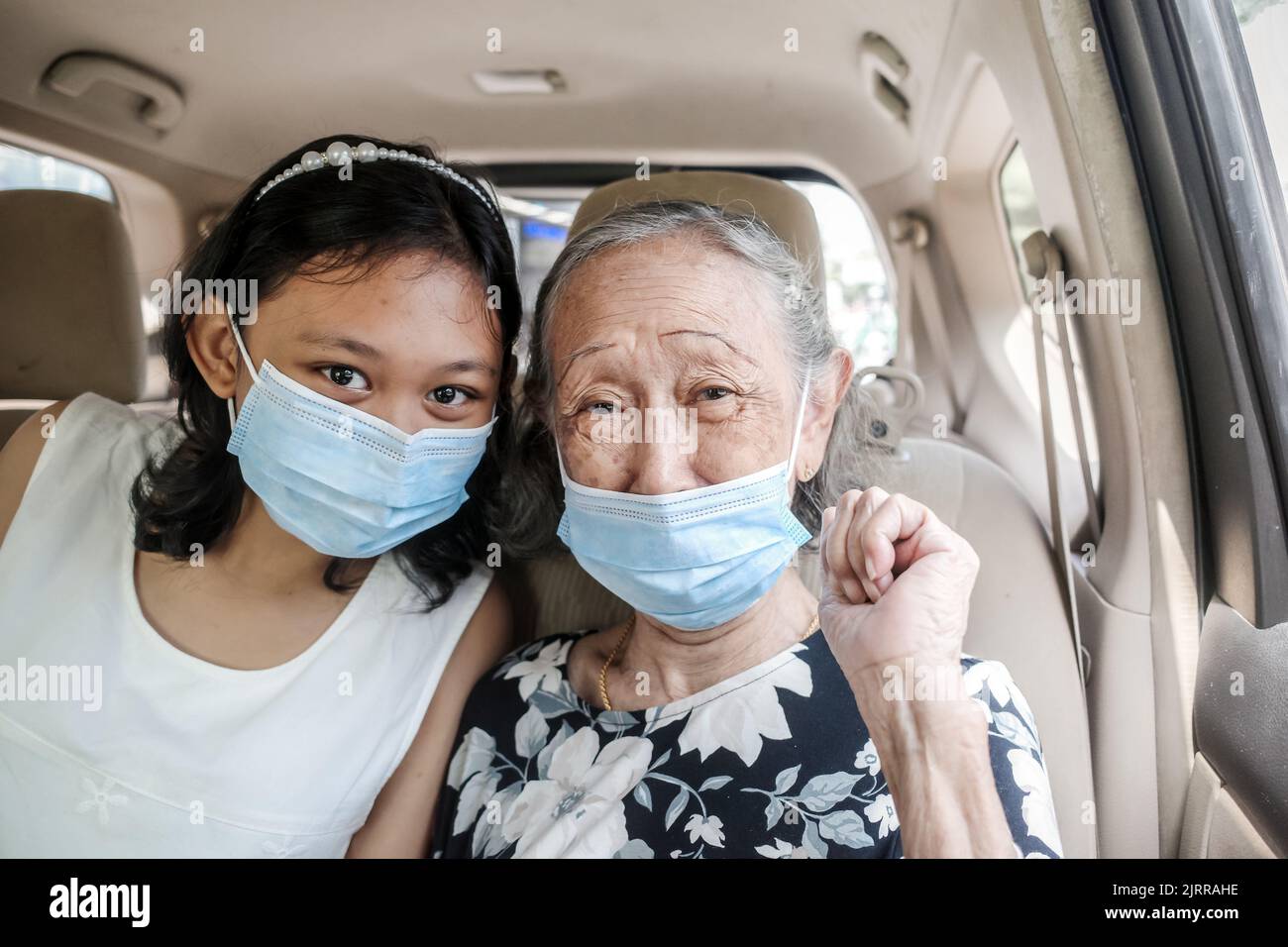 Smiling and Happy Asian Teen Girl and Grandma Wearing Face Masks in Car ...