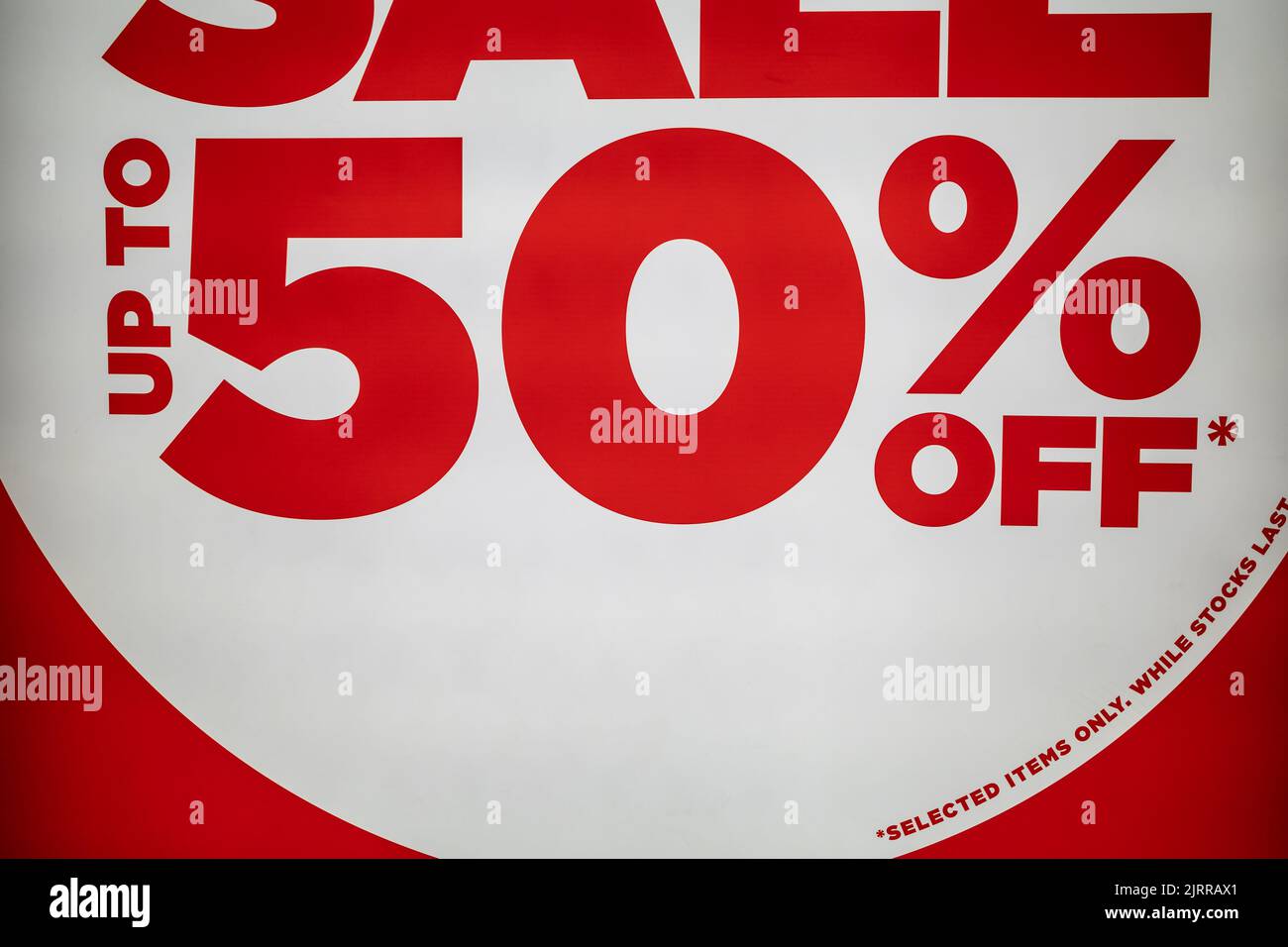 Closeup Red and White 50% Off Sale Sign on Fashion Store Exterior in a ...