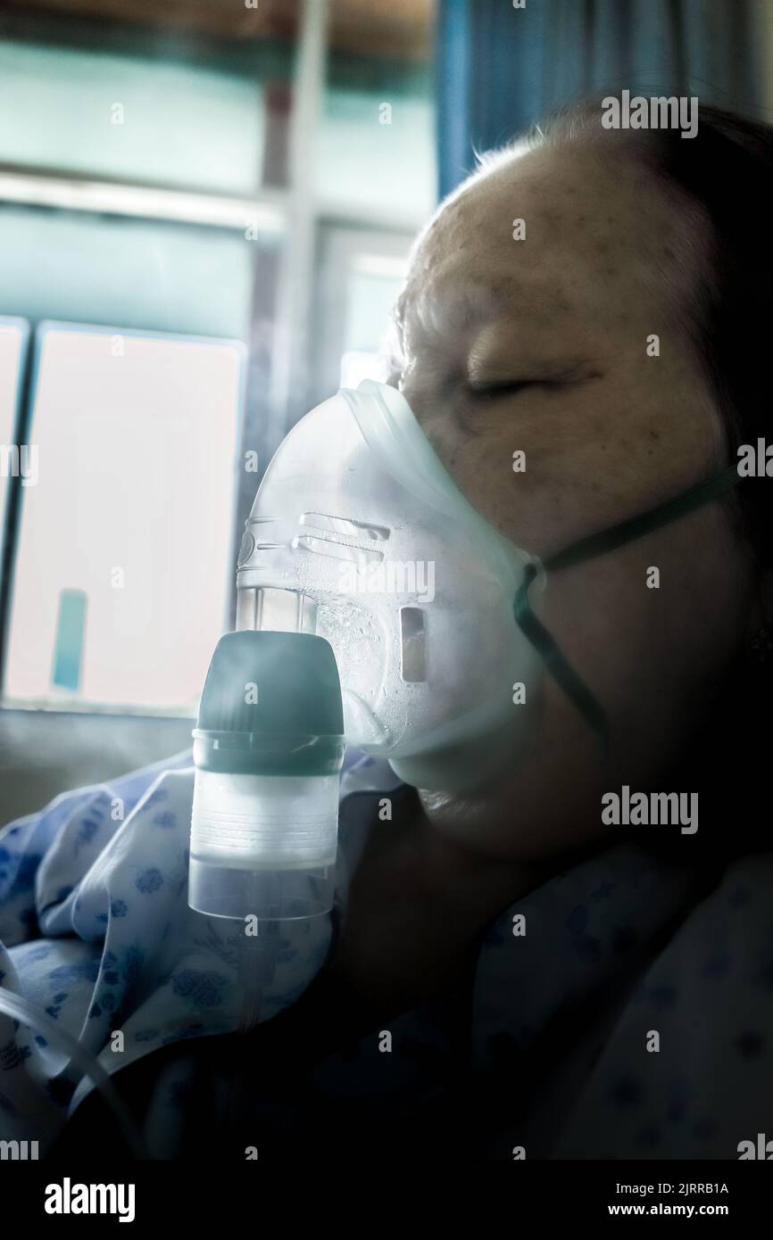 Southeast Asian female senior patient being treatment in hospital using ...