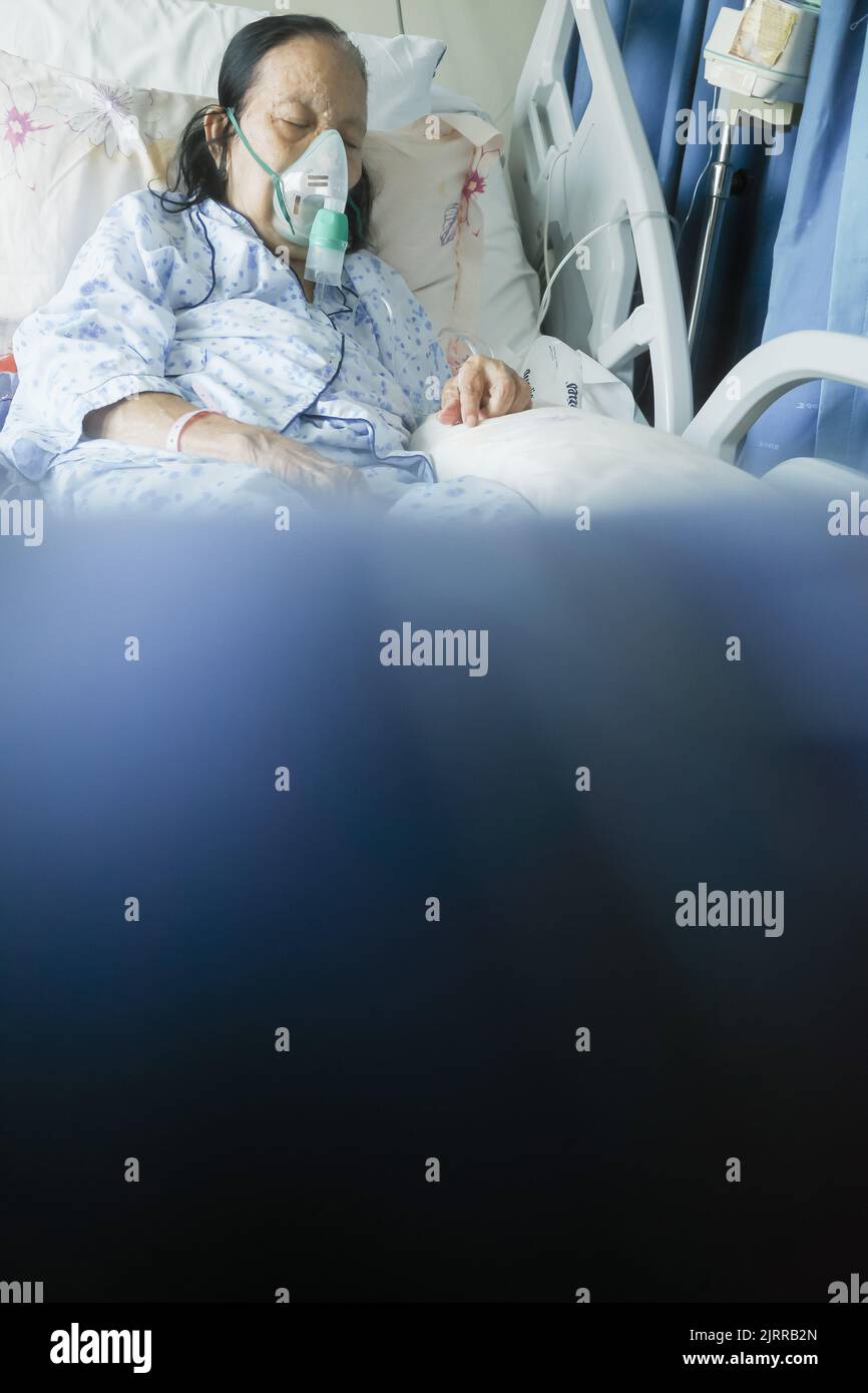 Southeast Asian female senior patient hospitalized and undergoing ...