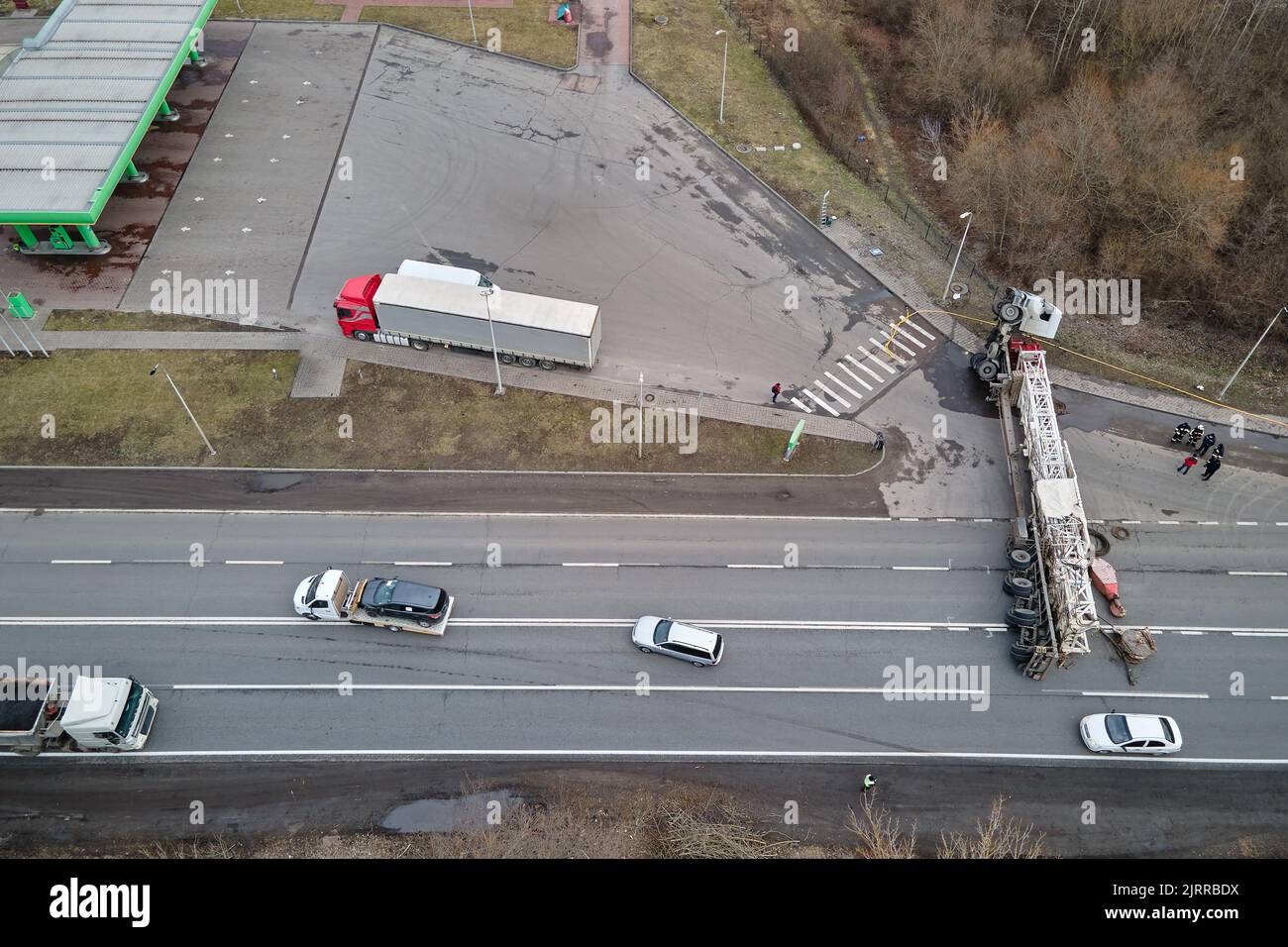 Aerial view of road accident with overturned truck blocking traffic ...