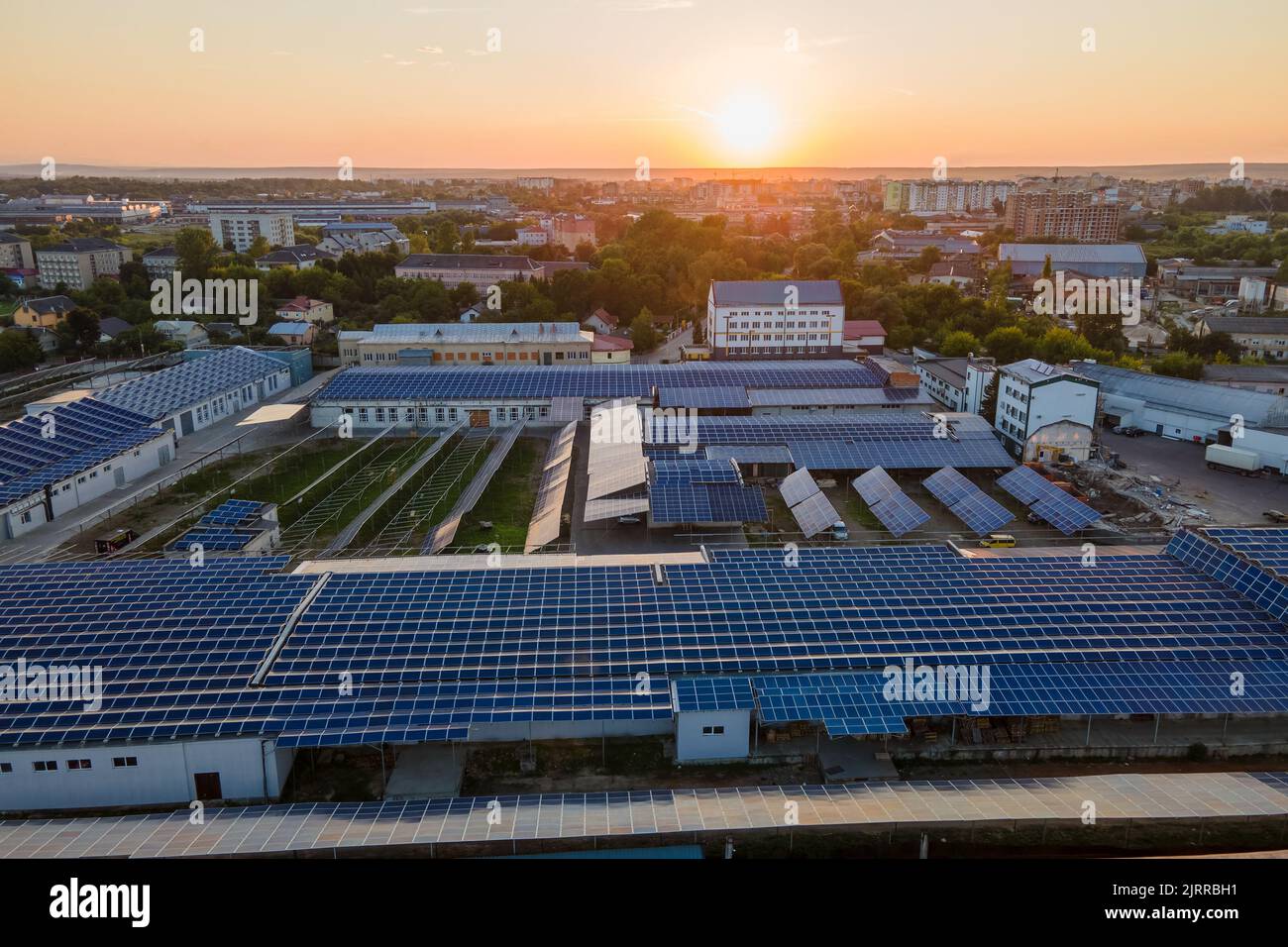 Aerial view of solar power plant with blue photovoltaic panels mounted ...