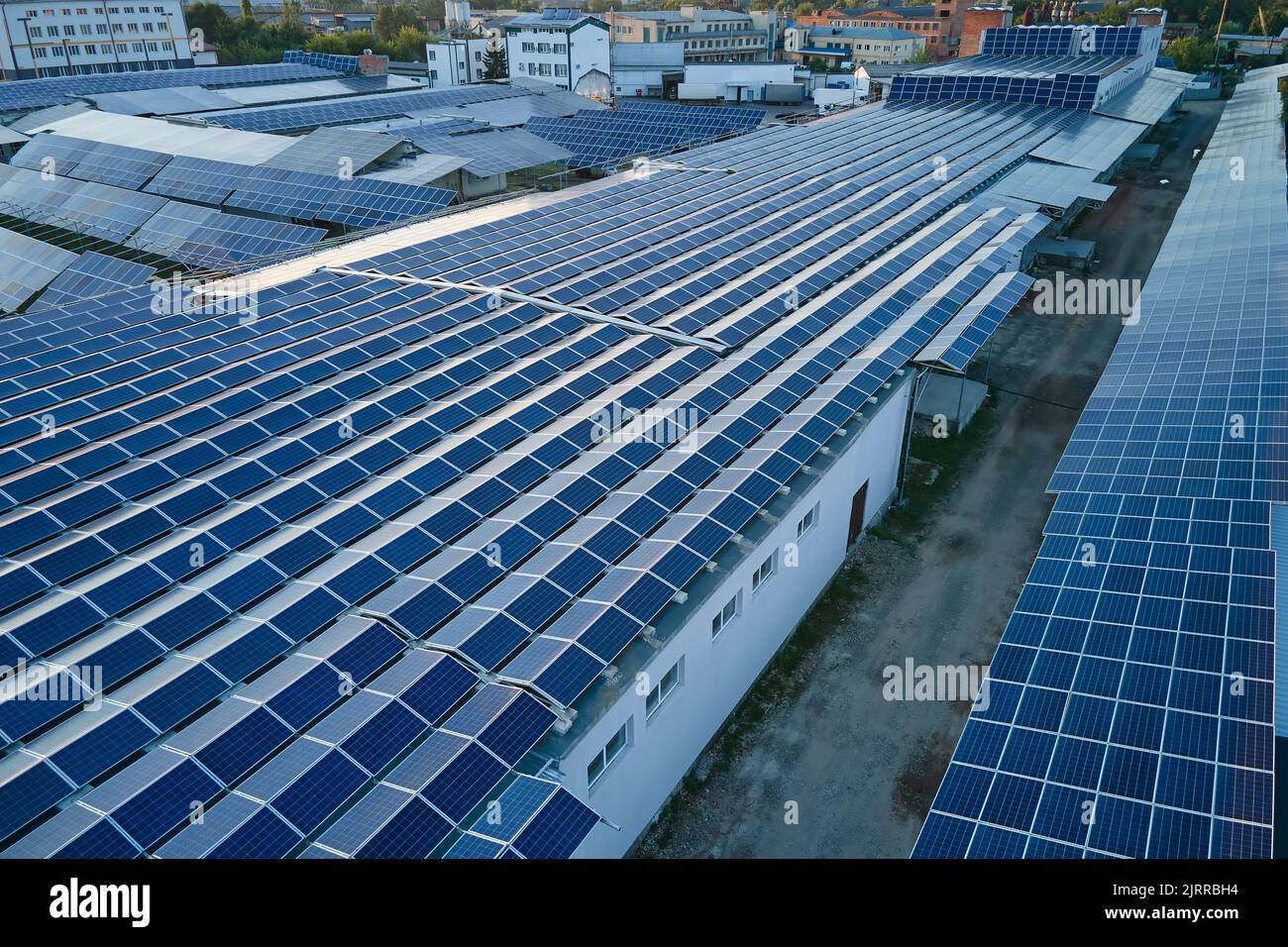 Aerial view of solar power plant with blue photovoltaic panels mounted ...